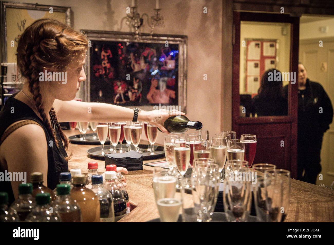Bar staff serving champagne at a Christmas office party at Bush Hall in ...