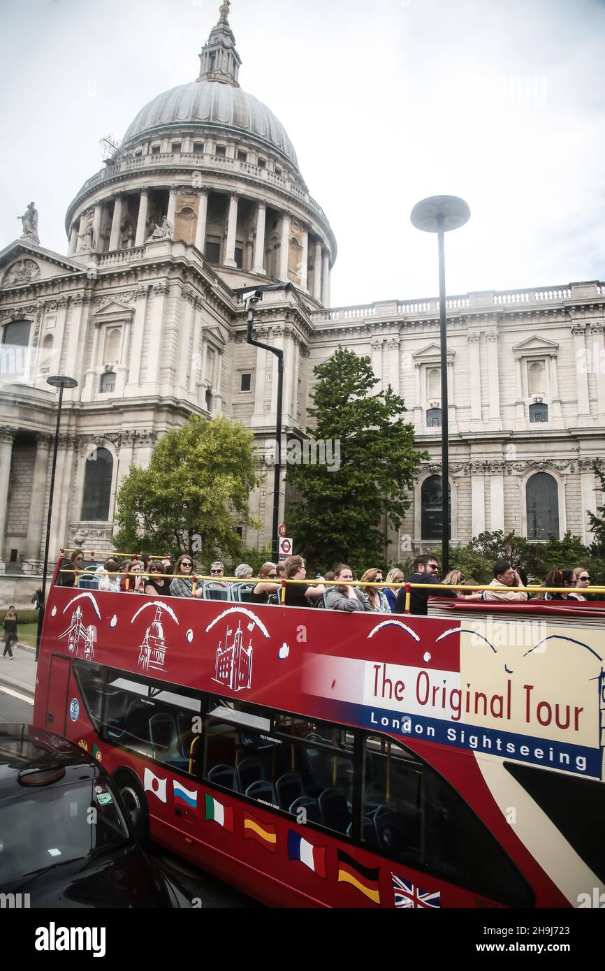 A tourist bus passes in front of St Paul's Cathedral in London. Part of ...