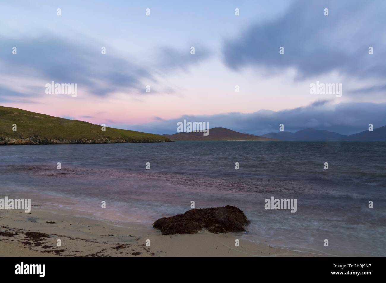 Dawn colours reflected in the sea at Horgabost beach, Isle of Lewis and ...