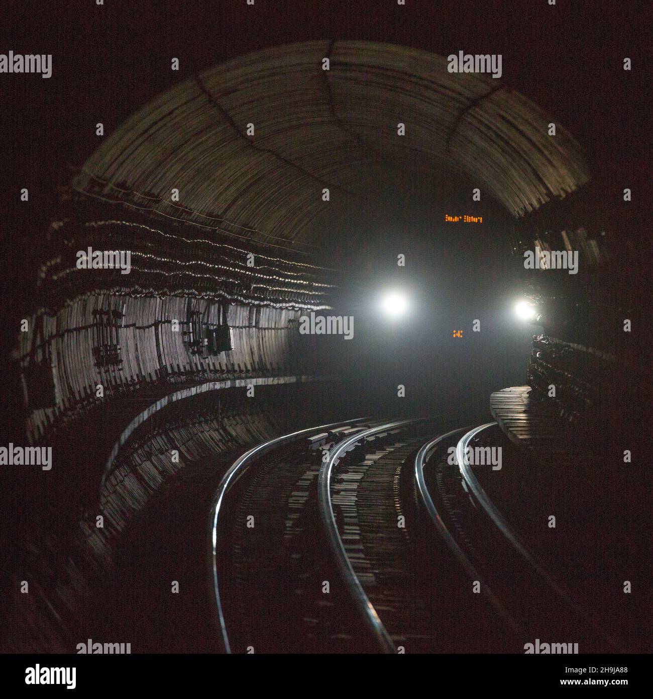 A tube train coming around a bend before arriving at Pimlico station on ...