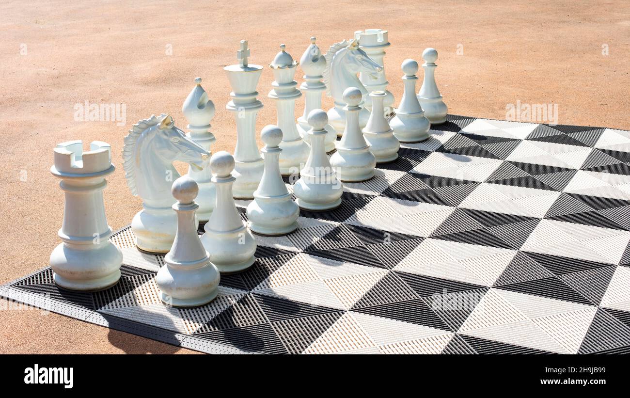 White chess pieces for outdoor play, horizontal photography. Beautiful ...