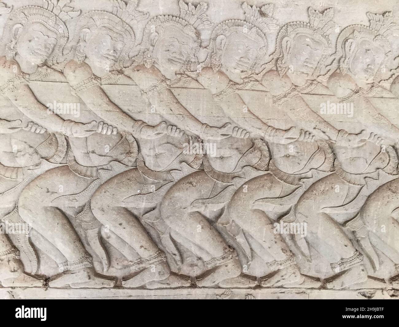 A carving featuring the churning of the sea of milk in the Angkor ...