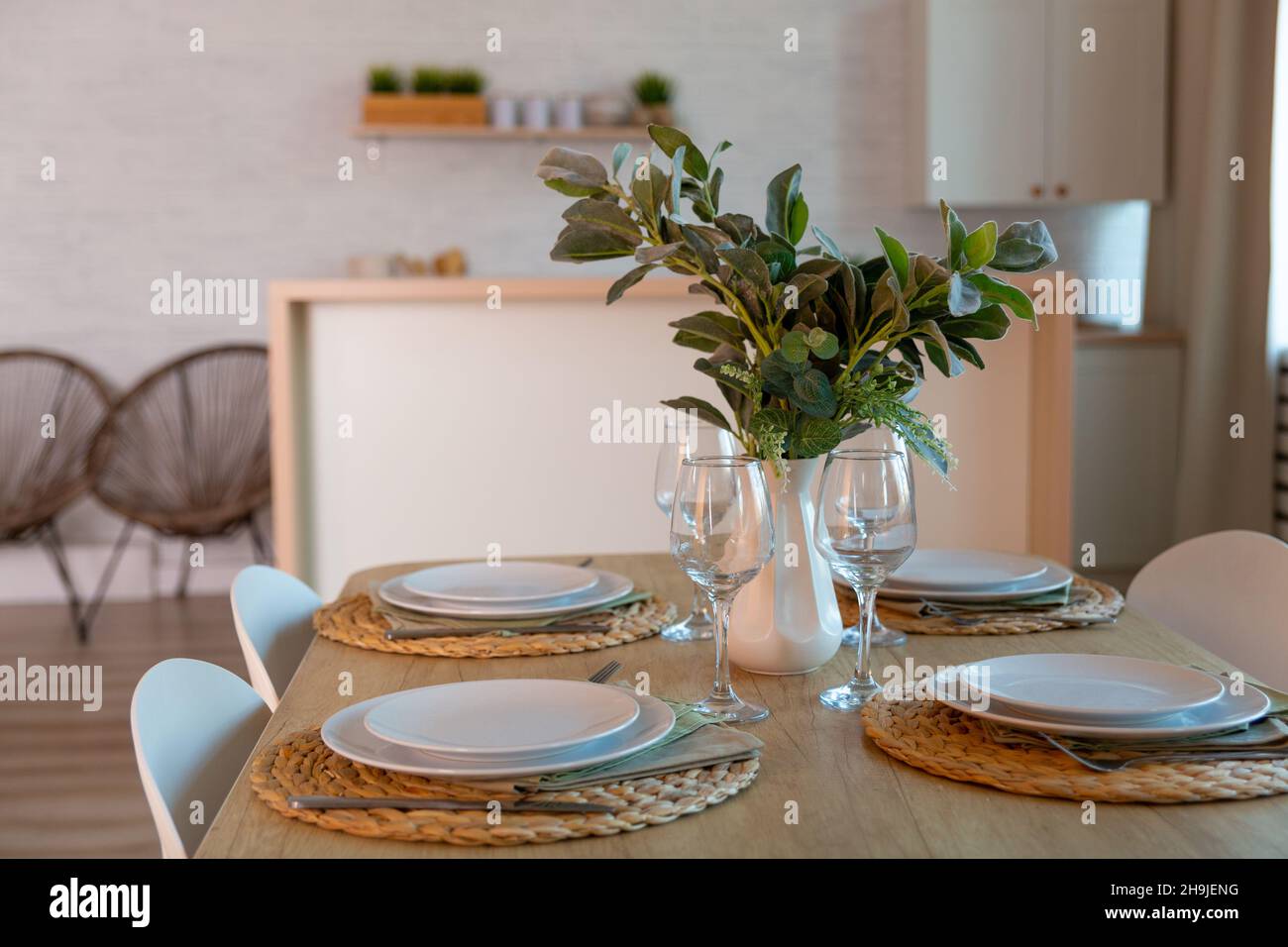 Breakfast setup on wooden table with nice vase and modern chair. A ...