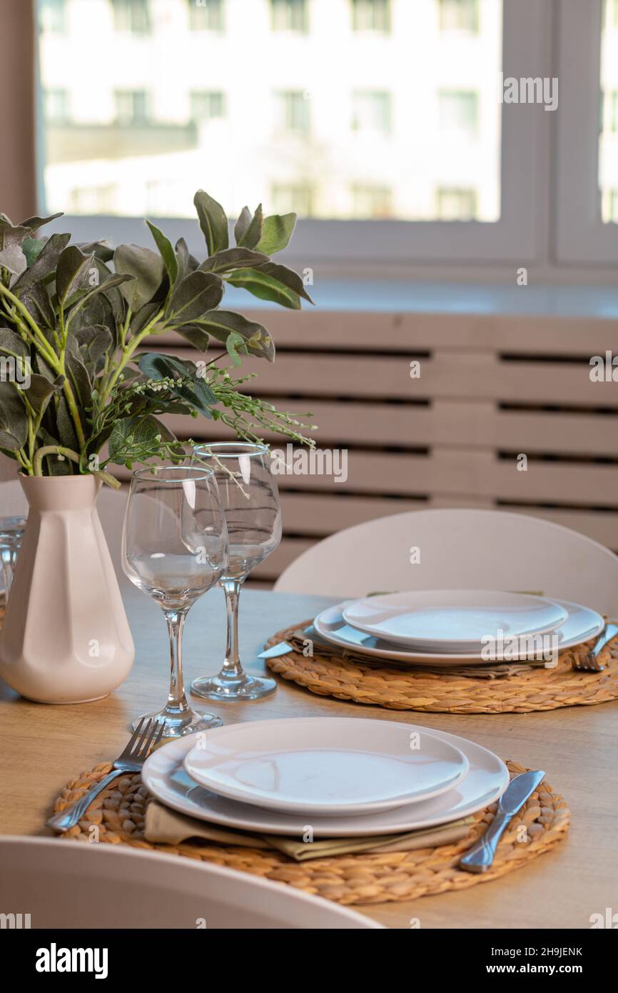 Breakfast setup on wooden table with nice vase and modern chair. A ...