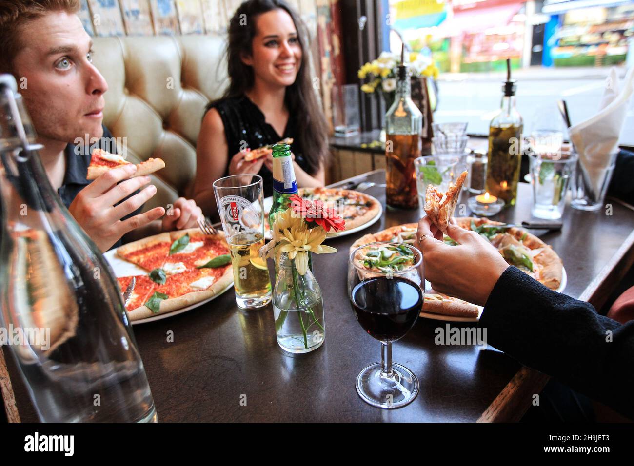 Pictures of people eating and being served pizza at Bush Hall's ...