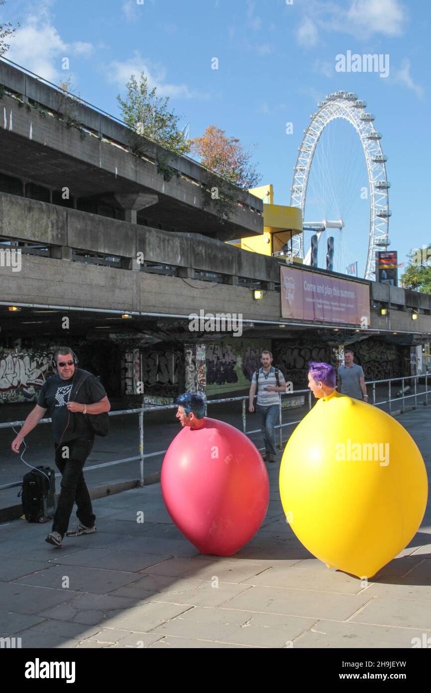 New York clown duo Acrobuffos speak to a passer-by while performing ...