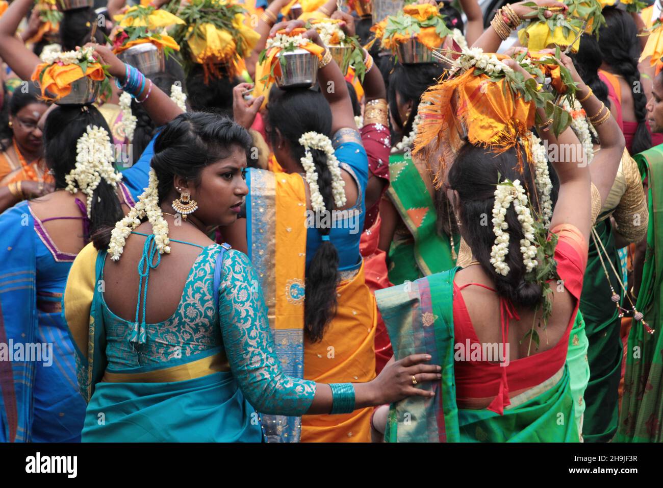 Women carrying pots of milk on their heads, known as paal kudam, during ...