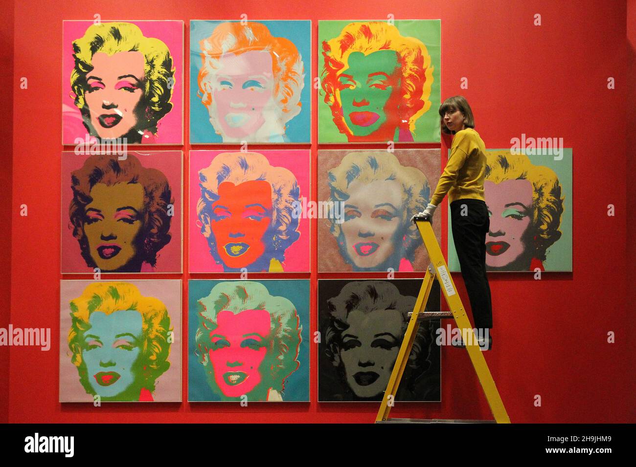 Project curator Catherine Daunt checks 10 "Marilyn" screenprints by ...