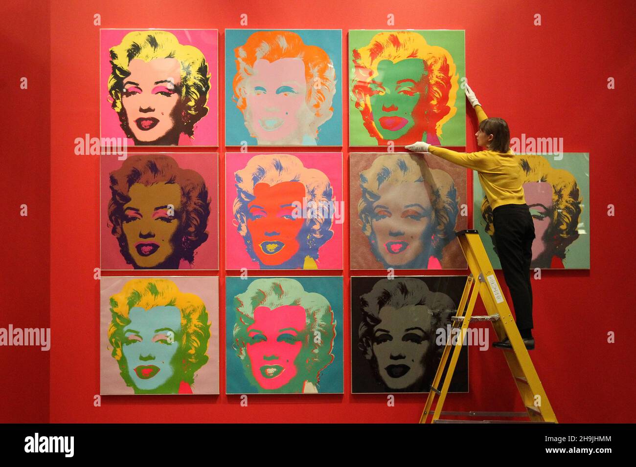 Project curator Catherine Daunt checks 10 "Marilyn" screenprints by ...