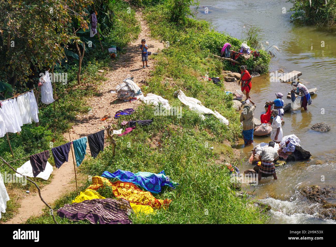 Locals washing clothes in a river. From a series of travel photos in ...