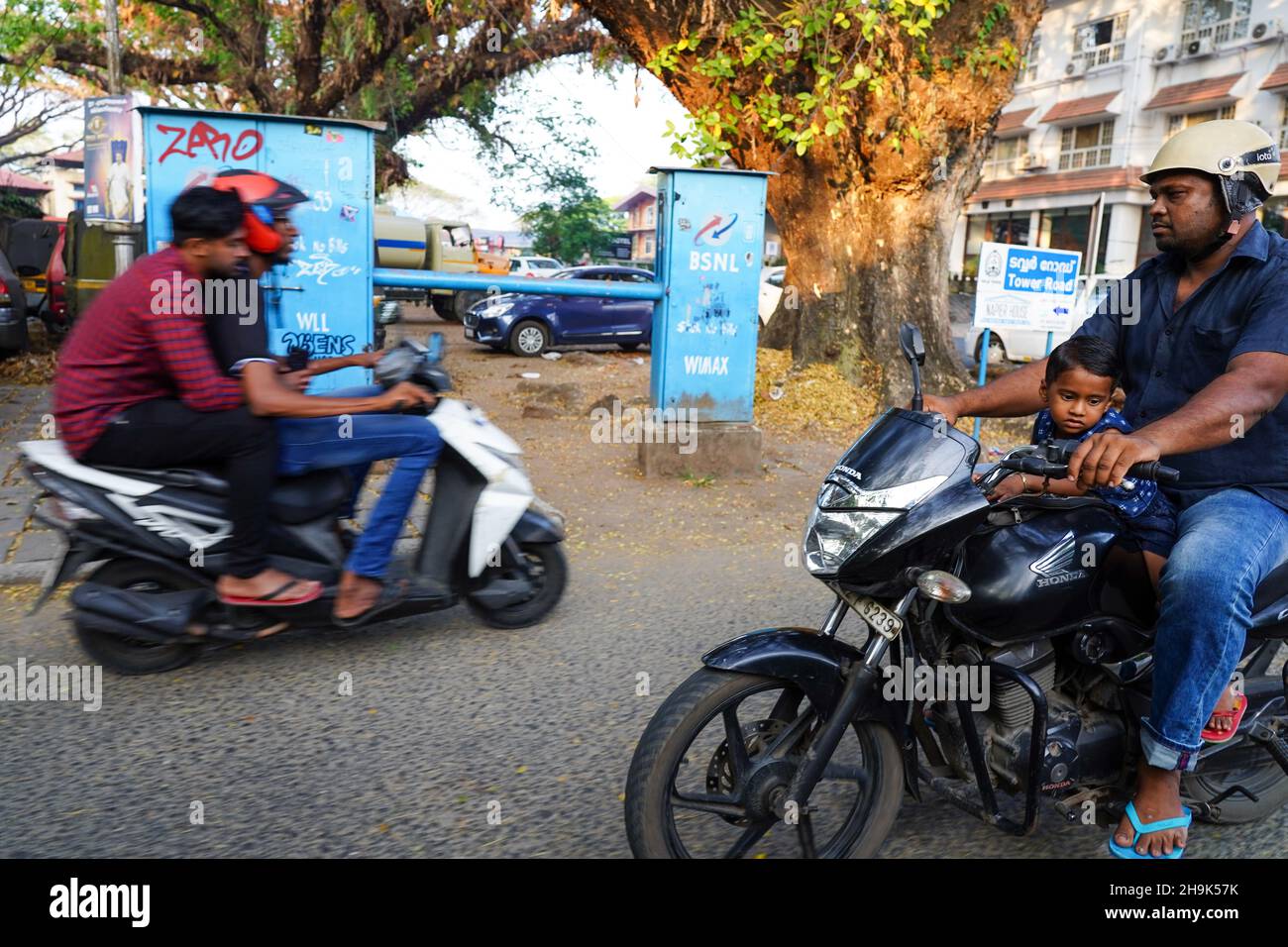 Views of riders of motorcycles and mopeds in Cochin, Kerala. From a ...
