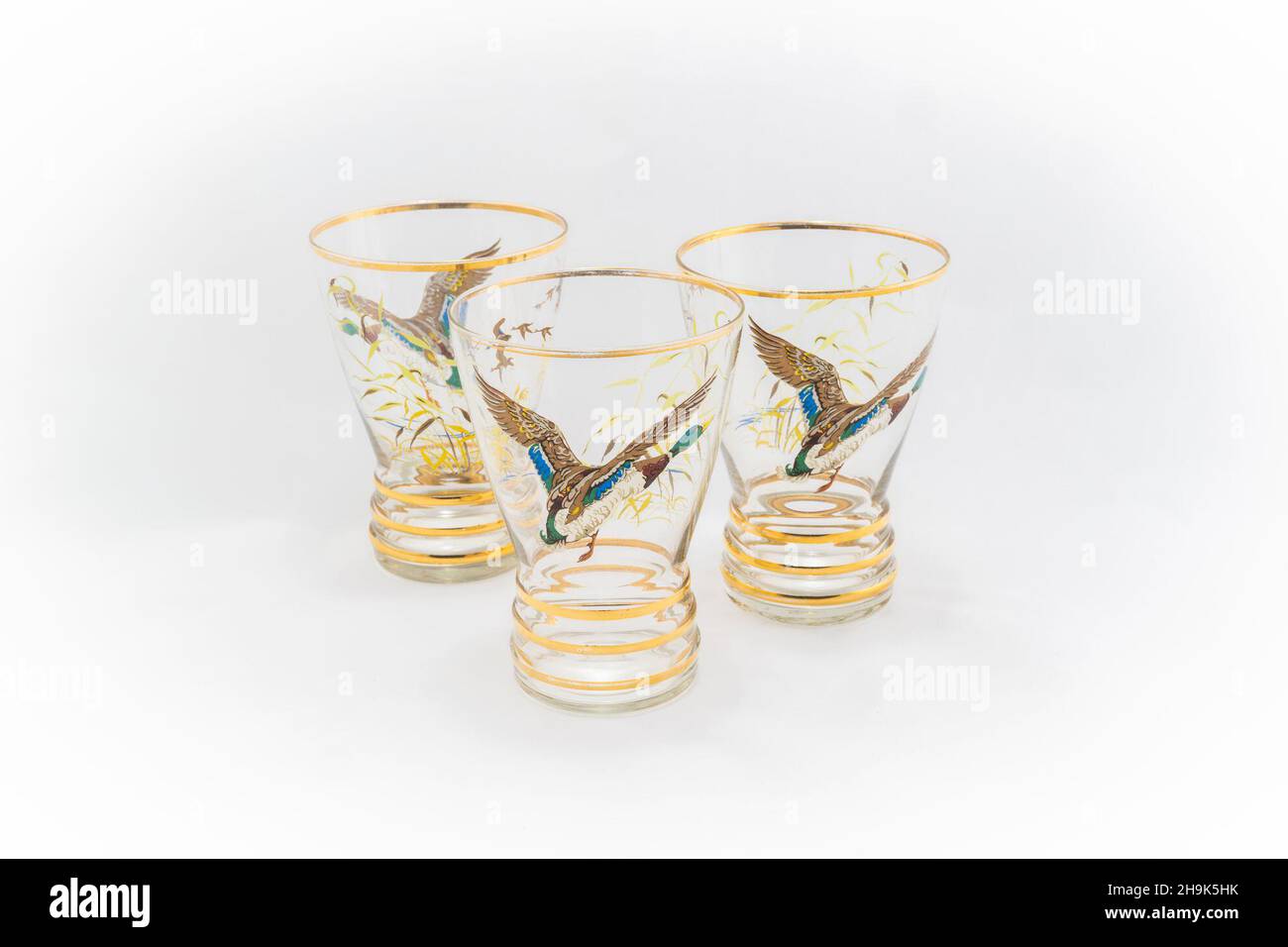 Three vintage shot glasses with hand-painted images of ducks, an image ...