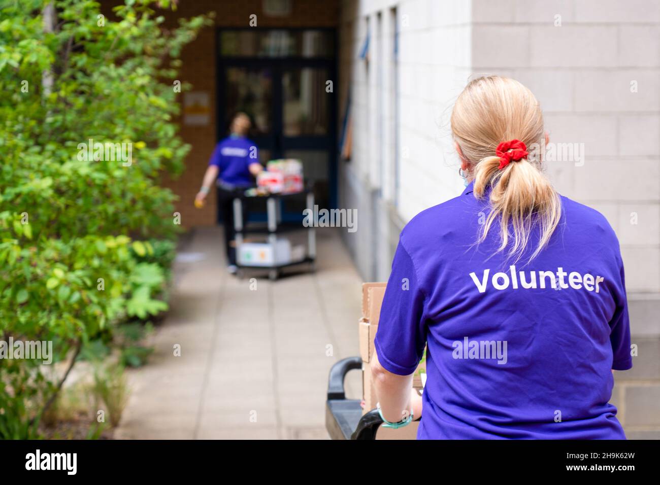 Two NHS volunteers delivering food to staff in Hammersmith Hospital in ...
