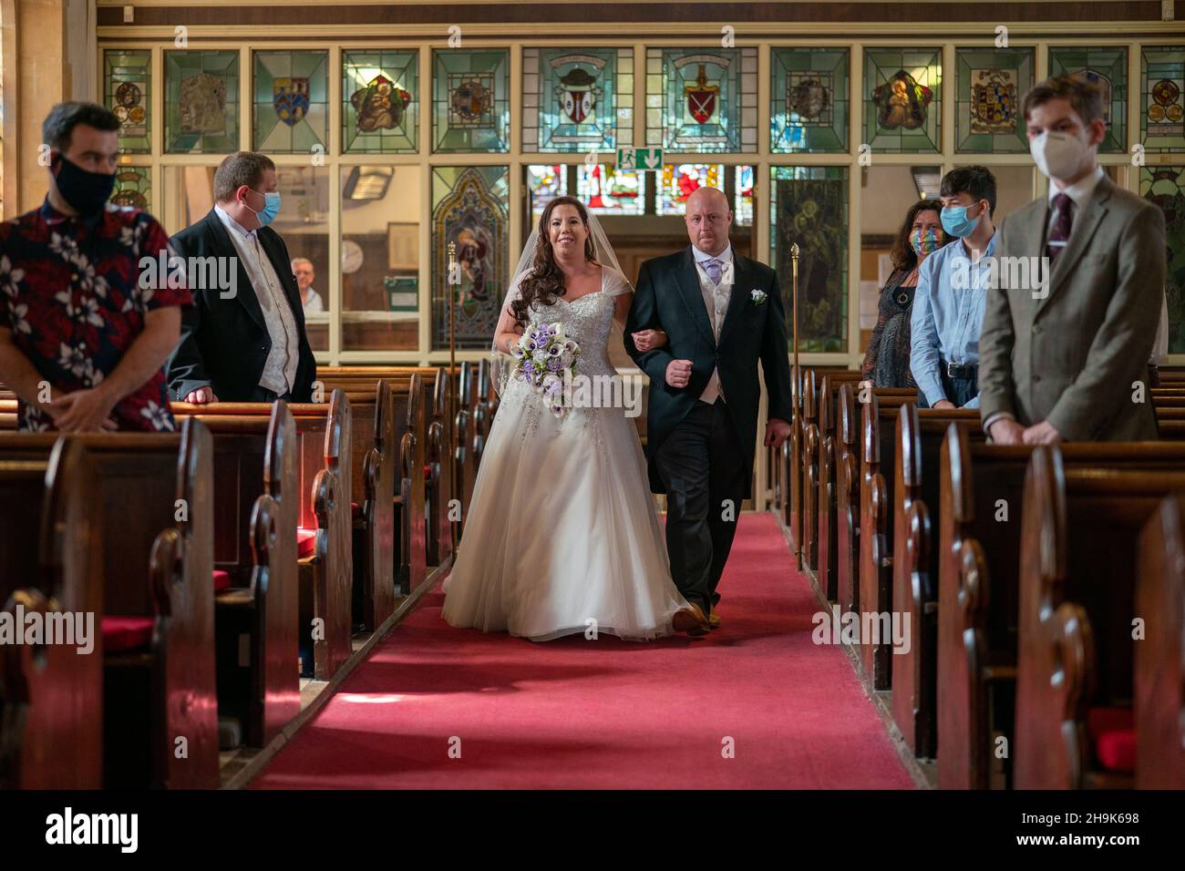 Samantha Fuller walks down the aisle with her brother, watched by ...