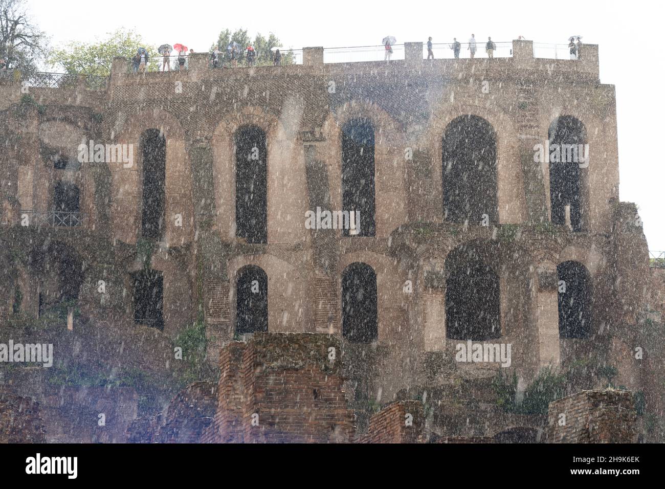 Tourists shelter from heavy rain in the Roman Forum in Rome, Italy ...