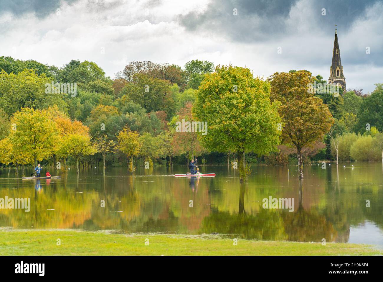 A family rows canoes across Brent Valley golf course in Hanwell, London ...