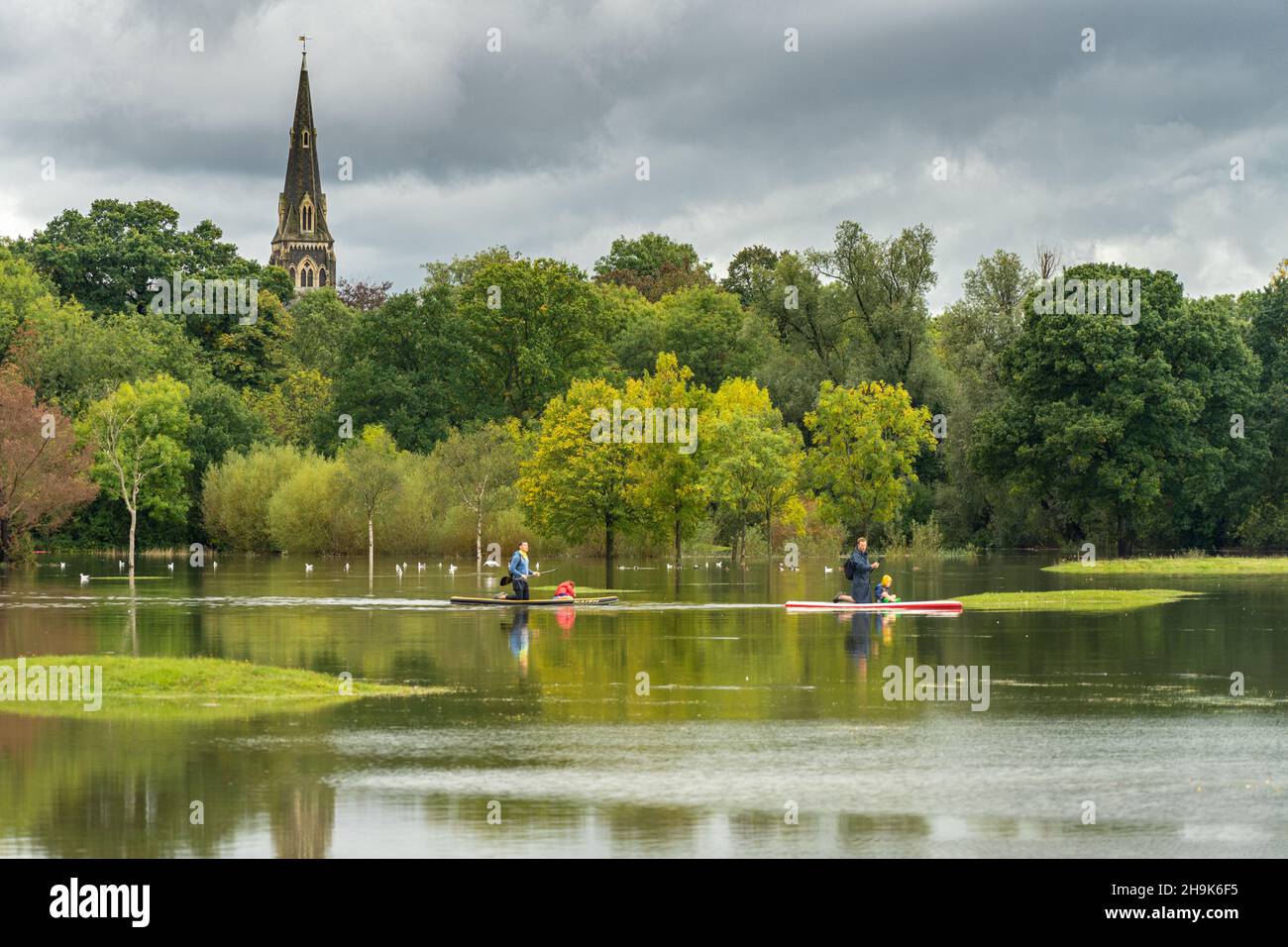 A family rows canoes across Brent Valley golf course in Hanwell, London ...