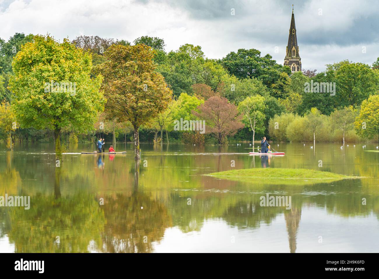 A family rows canoes across Brent Valley golf course in Hanwell, London ...