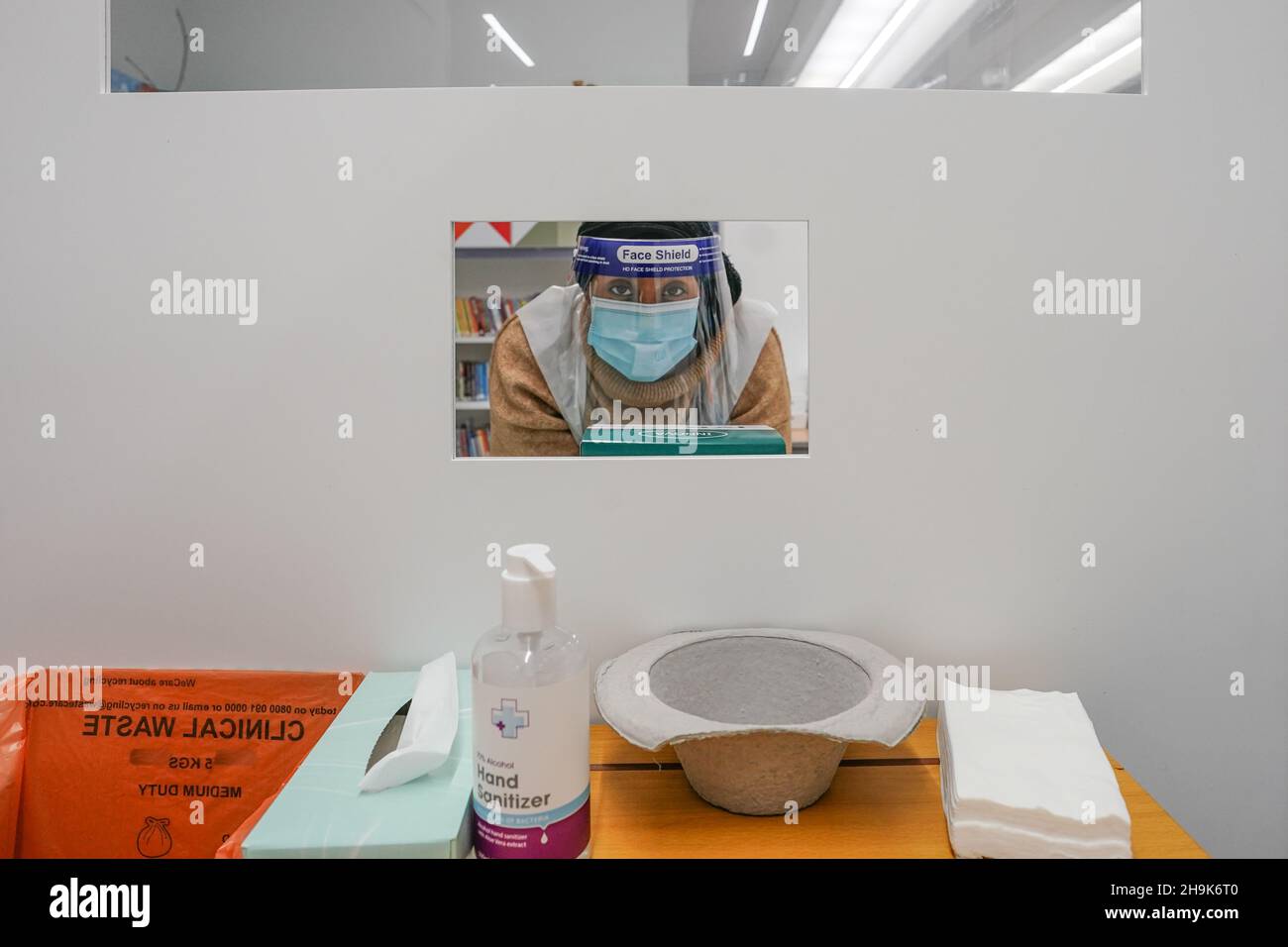 A clinician looks through a window at a lateral flow testing centre in ...