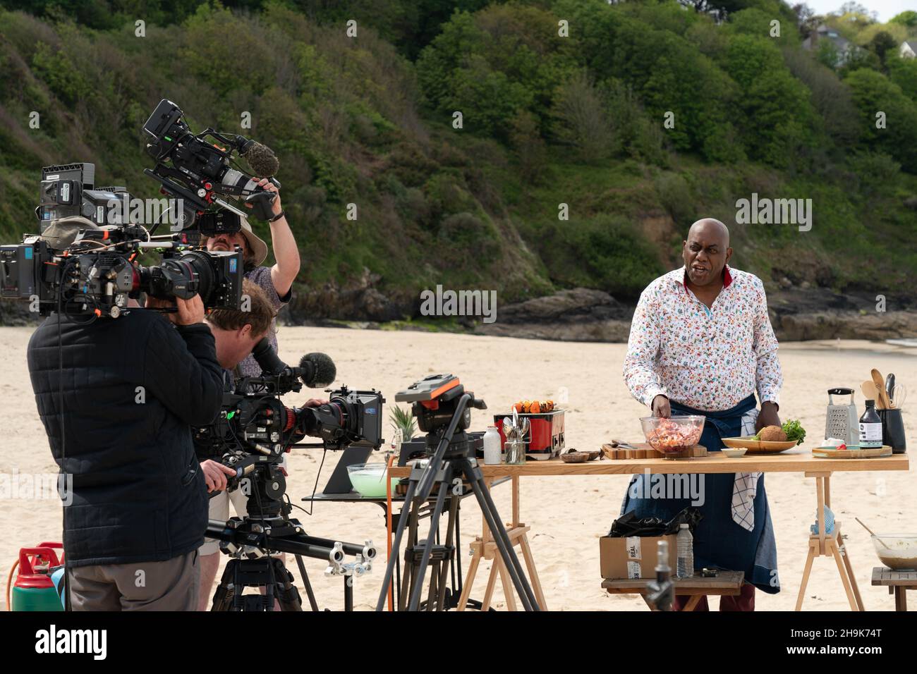 Ainsley Harriott being filmed making a programme on a beach in Cornwall ...