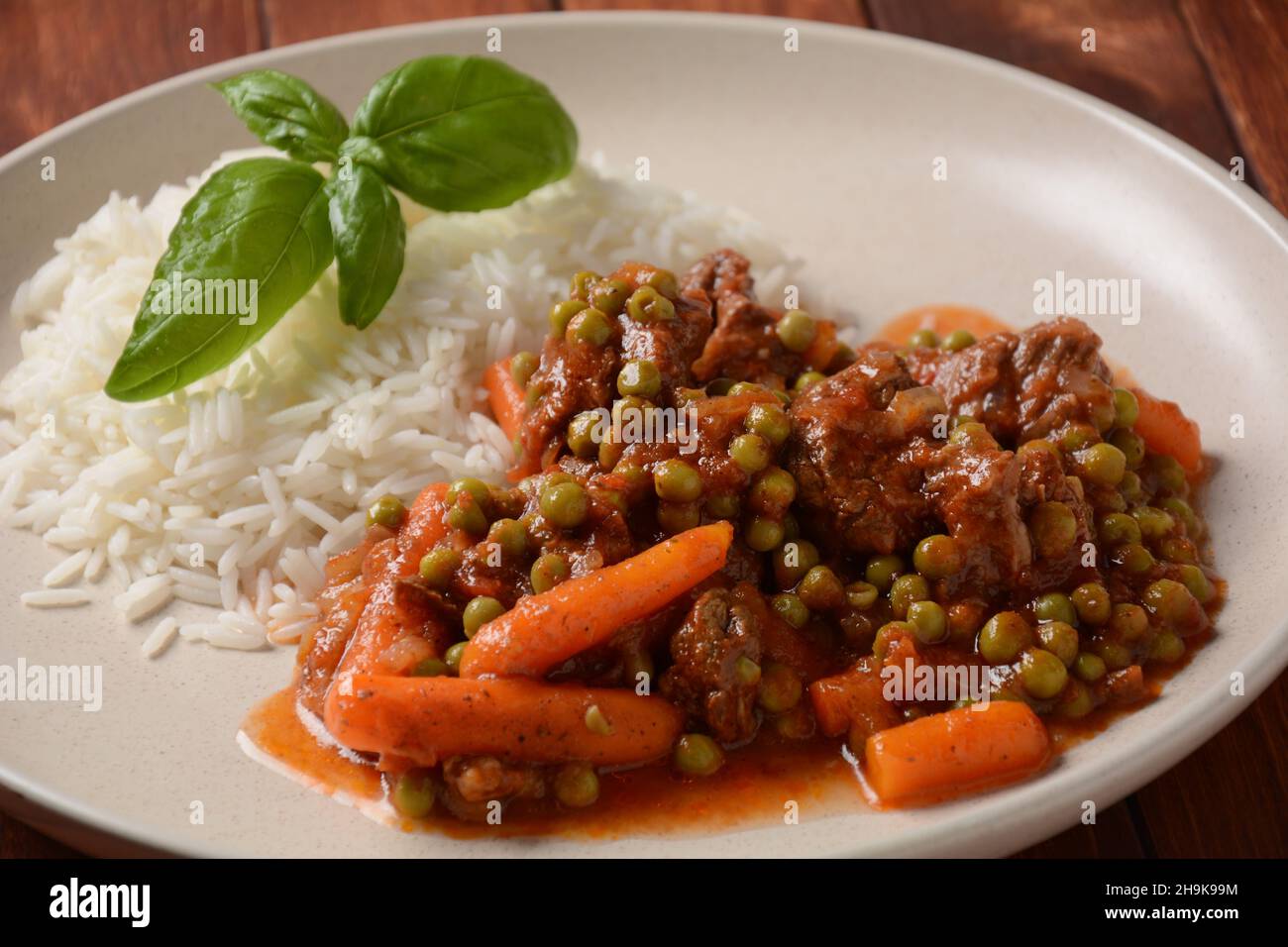 Beef stew, meat ragout with carrots, onions and green peas. Meat stew ...