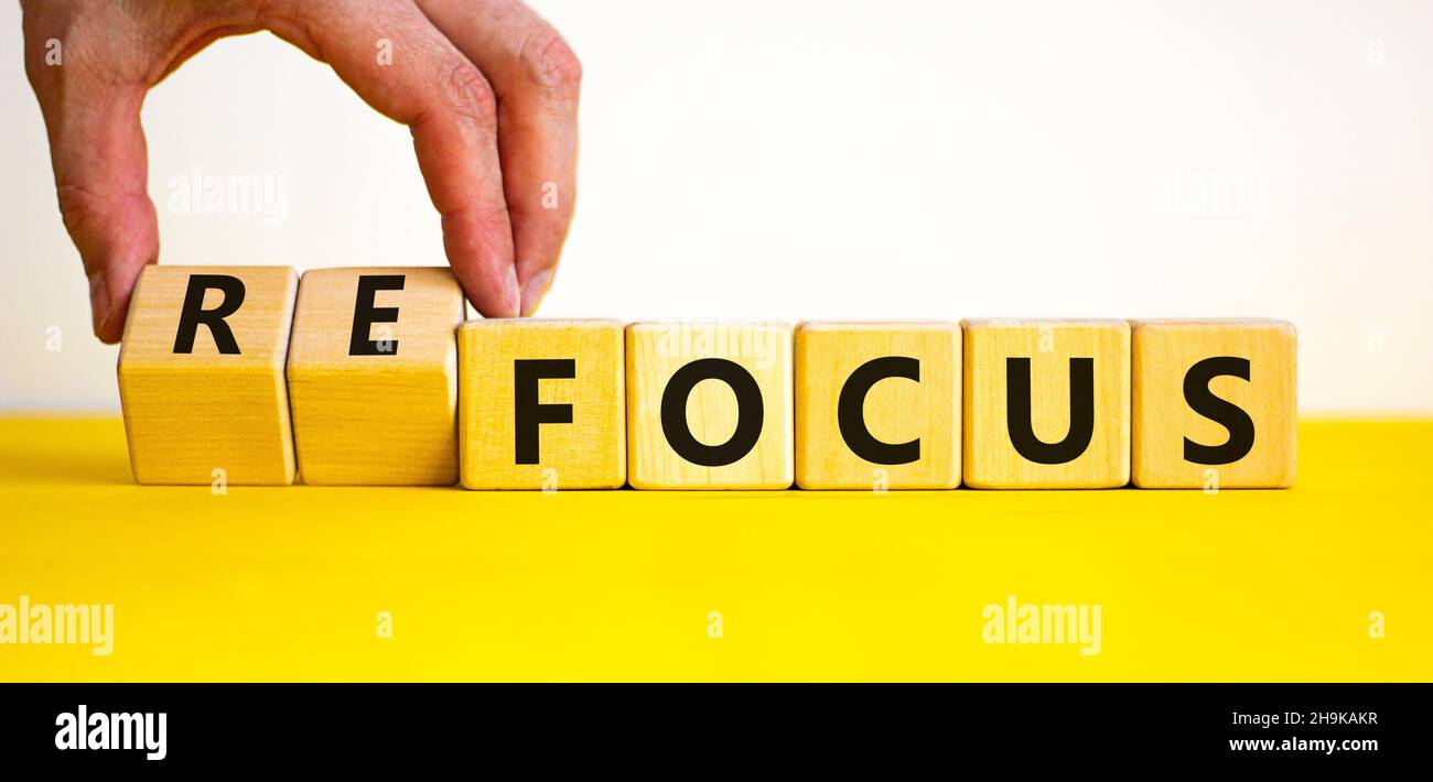 Focus or refocus symbol. Businessman turns wooden cubes and changes the ...