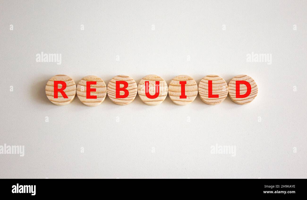 Rebuild and build symbol. The concept word Rebuild on wooden circles ...