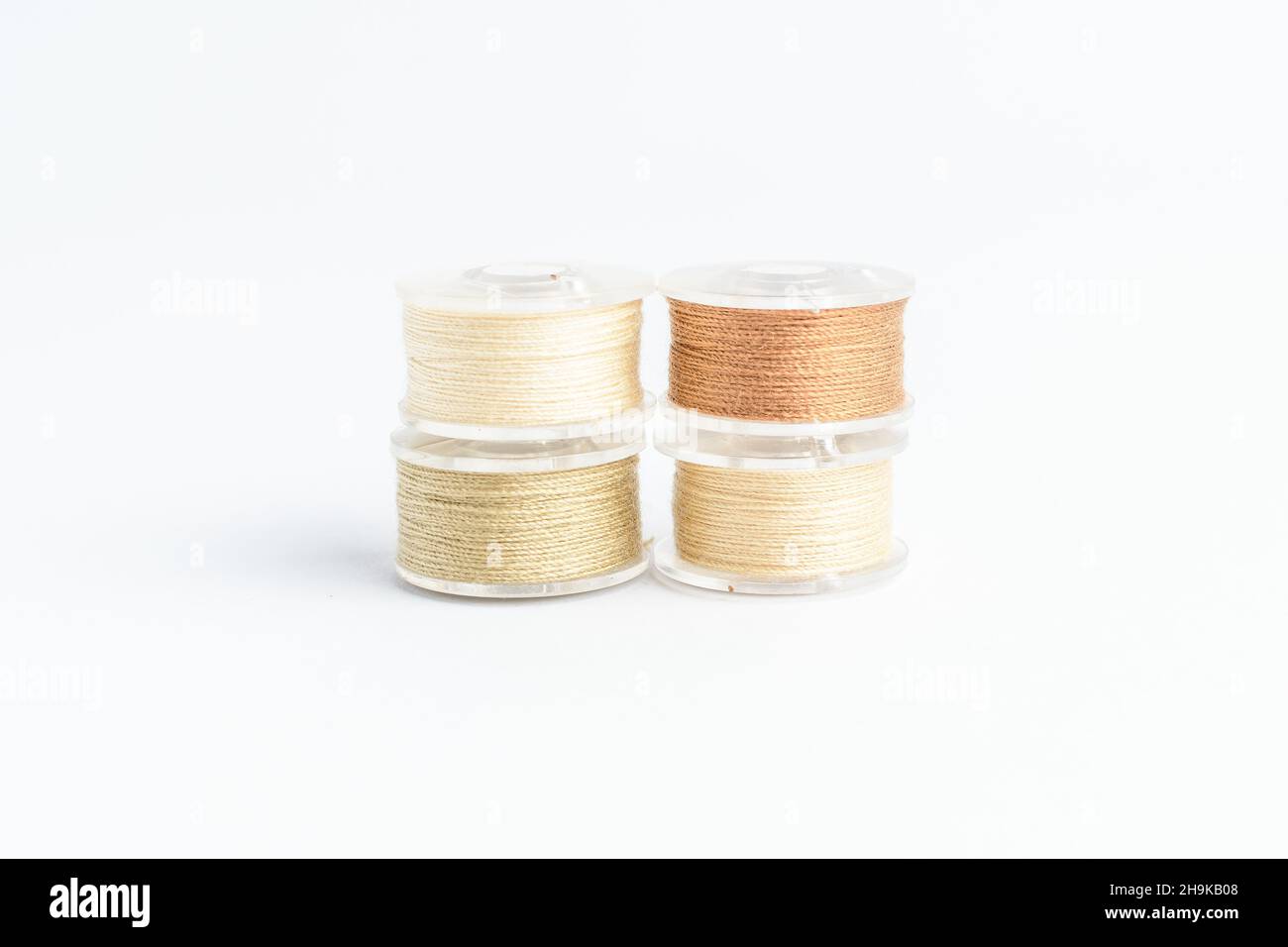 Different spools of mixed beige and brown cotton thread prepared for ...