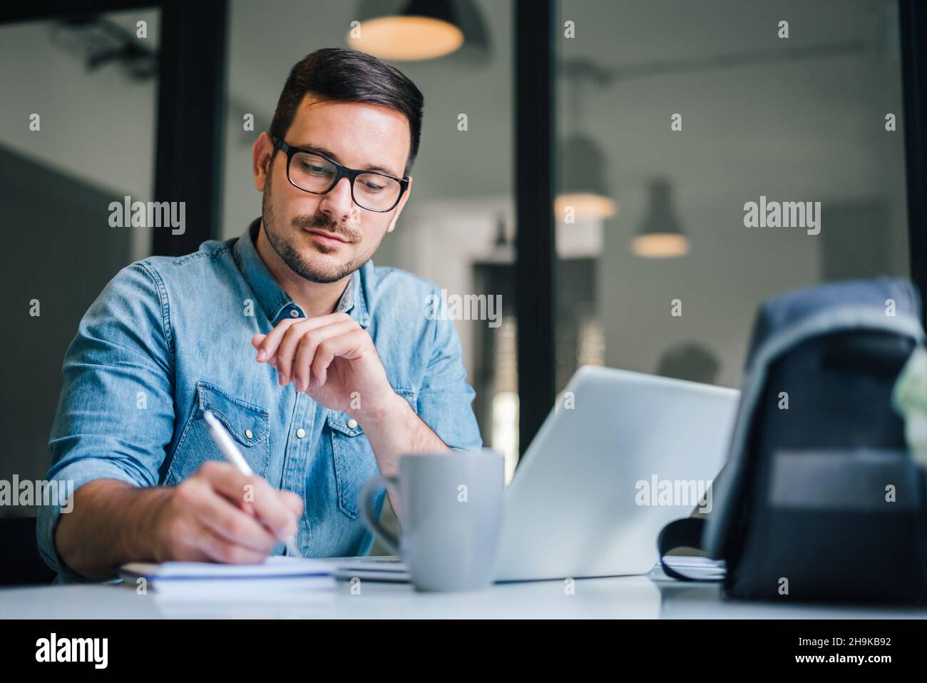 Close up portrait of handsome man working from home office taking ...