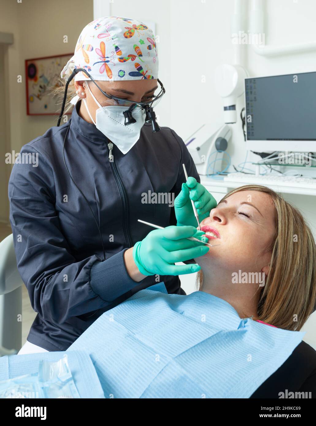 Young Blonde Female patient with open mouth examining dental inspection ...