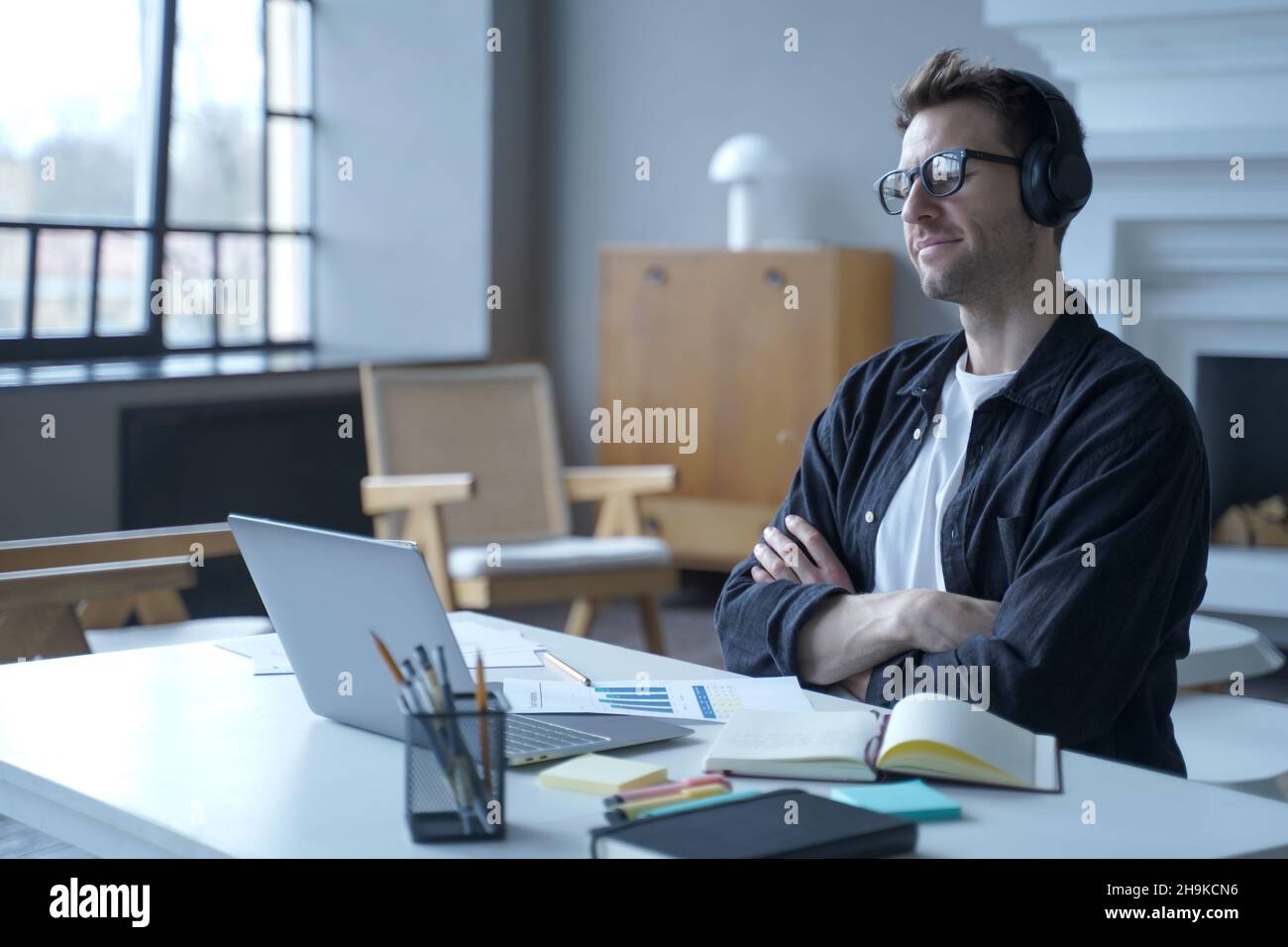 Positive German man bank employee sitting at workplace at modern home ...