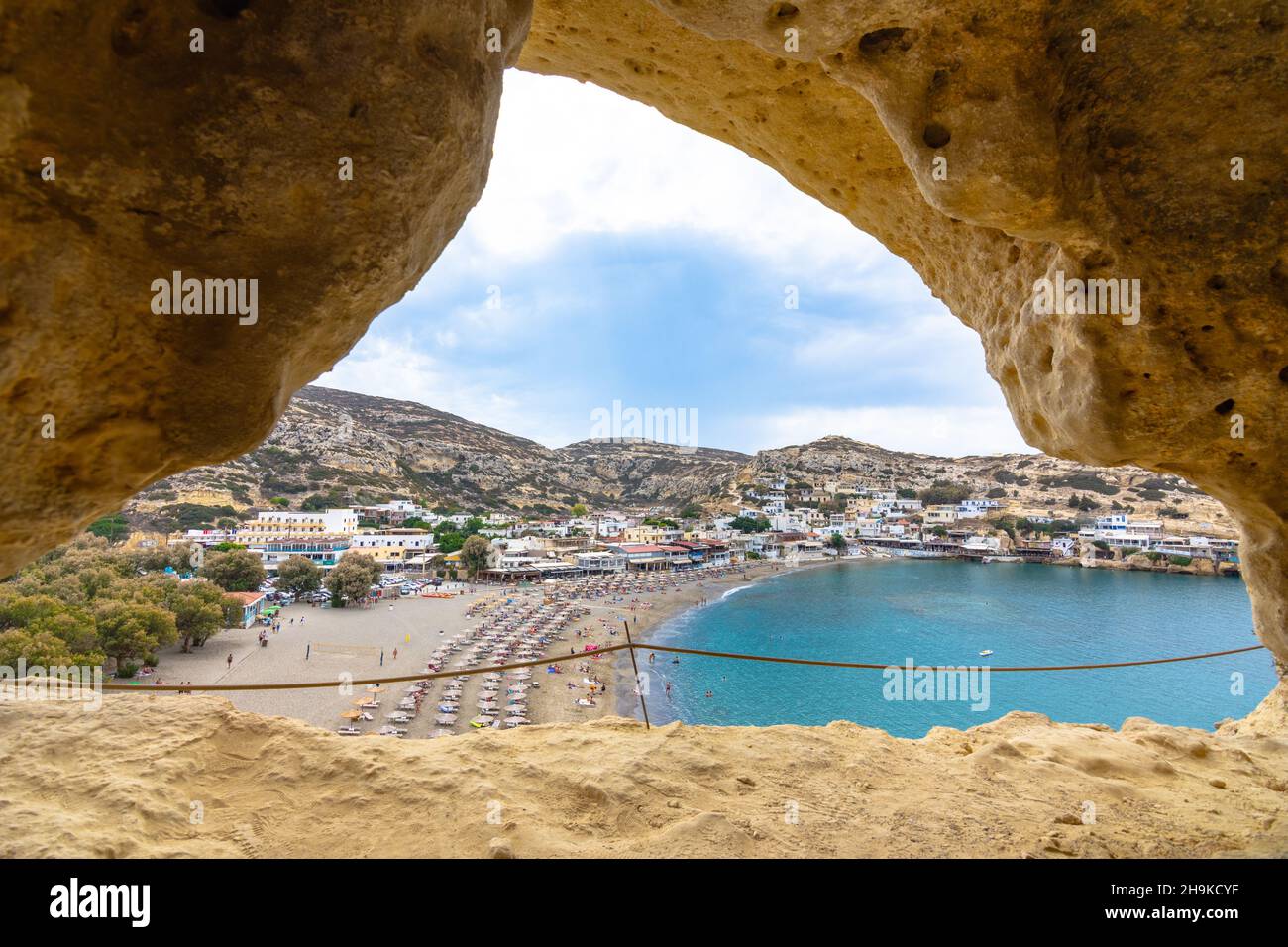 Matala beach with caves on the rocks that were used as a roman cemetery ...