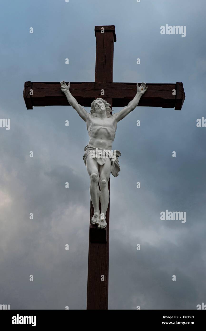 Crucifix of a white stone Jesus Christ on a dark wooden cross Stock ...
