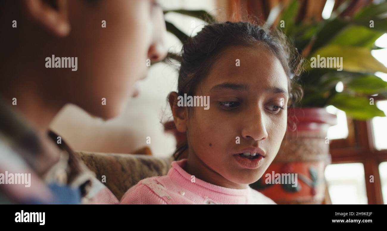 Shallow focus of young South Asian siblings having a conversation ...