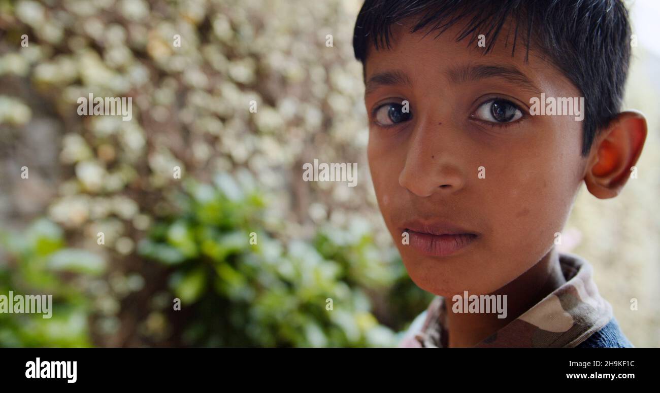 Shallow focus of a young Indian boy with a serious expression Stock ...