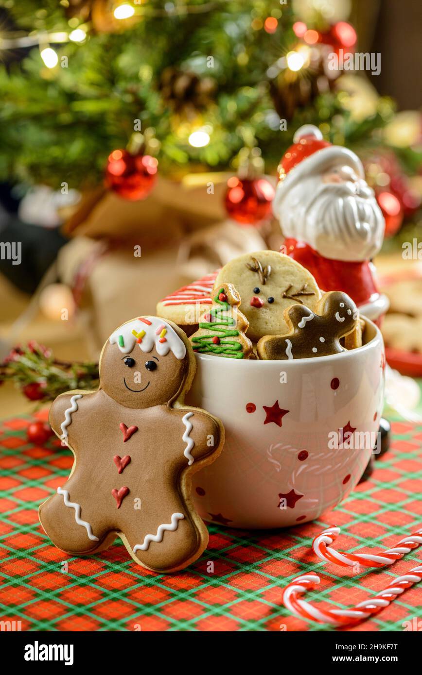 Christmas scene. Cookies gingerbread and others with blurred background ...