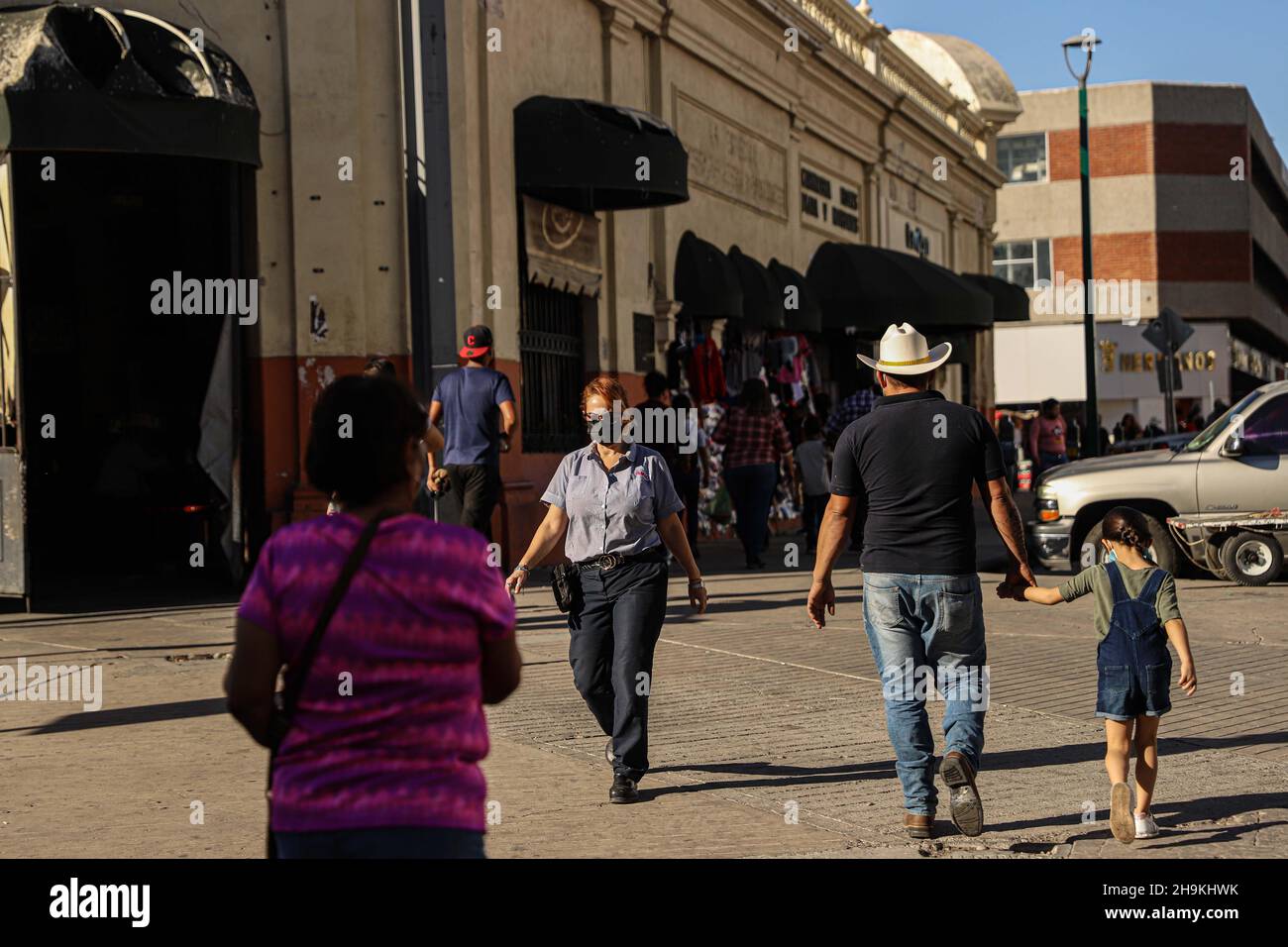 A father and his daughter walk through the Mercado Municipal in ...
