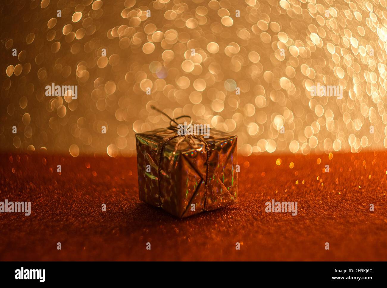 A shiny gift with bokeh in a retro style Stock Photo - Alamy