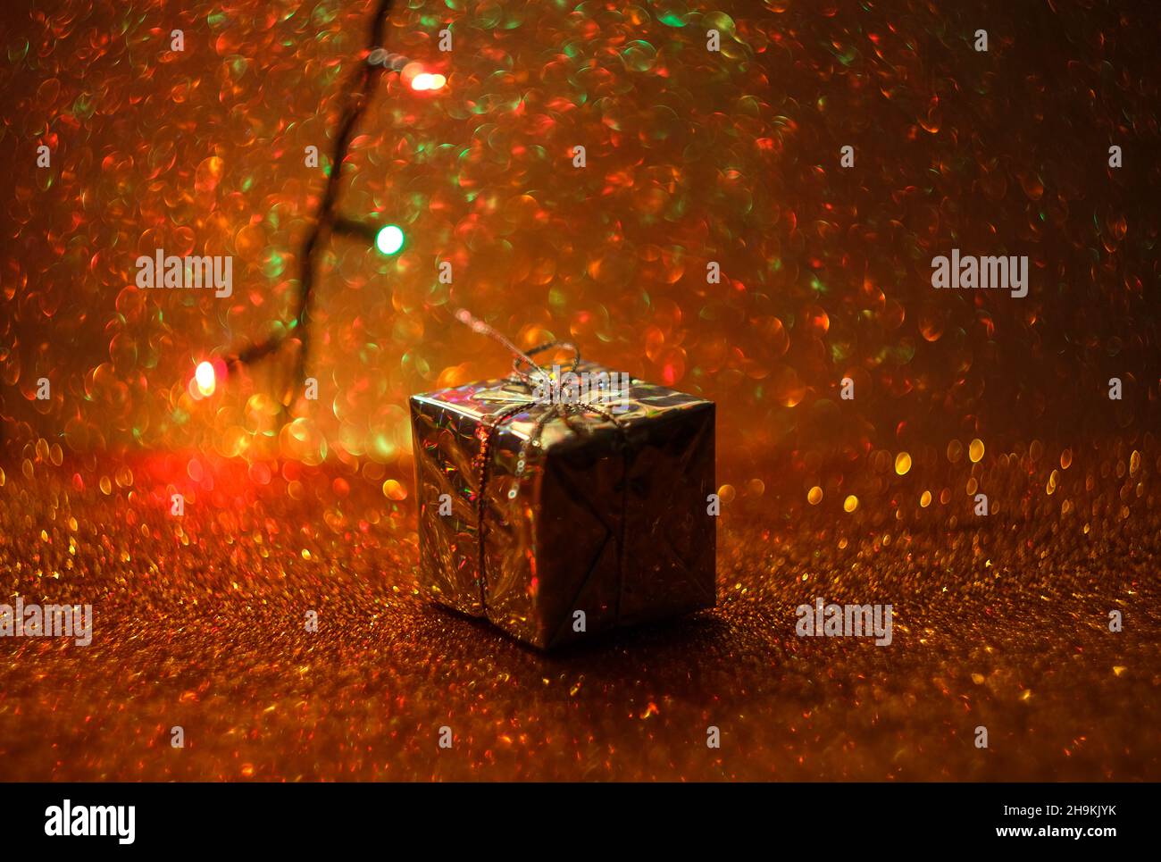 A shiny gift with bokeh in a retro style Stock Photo - Alamy