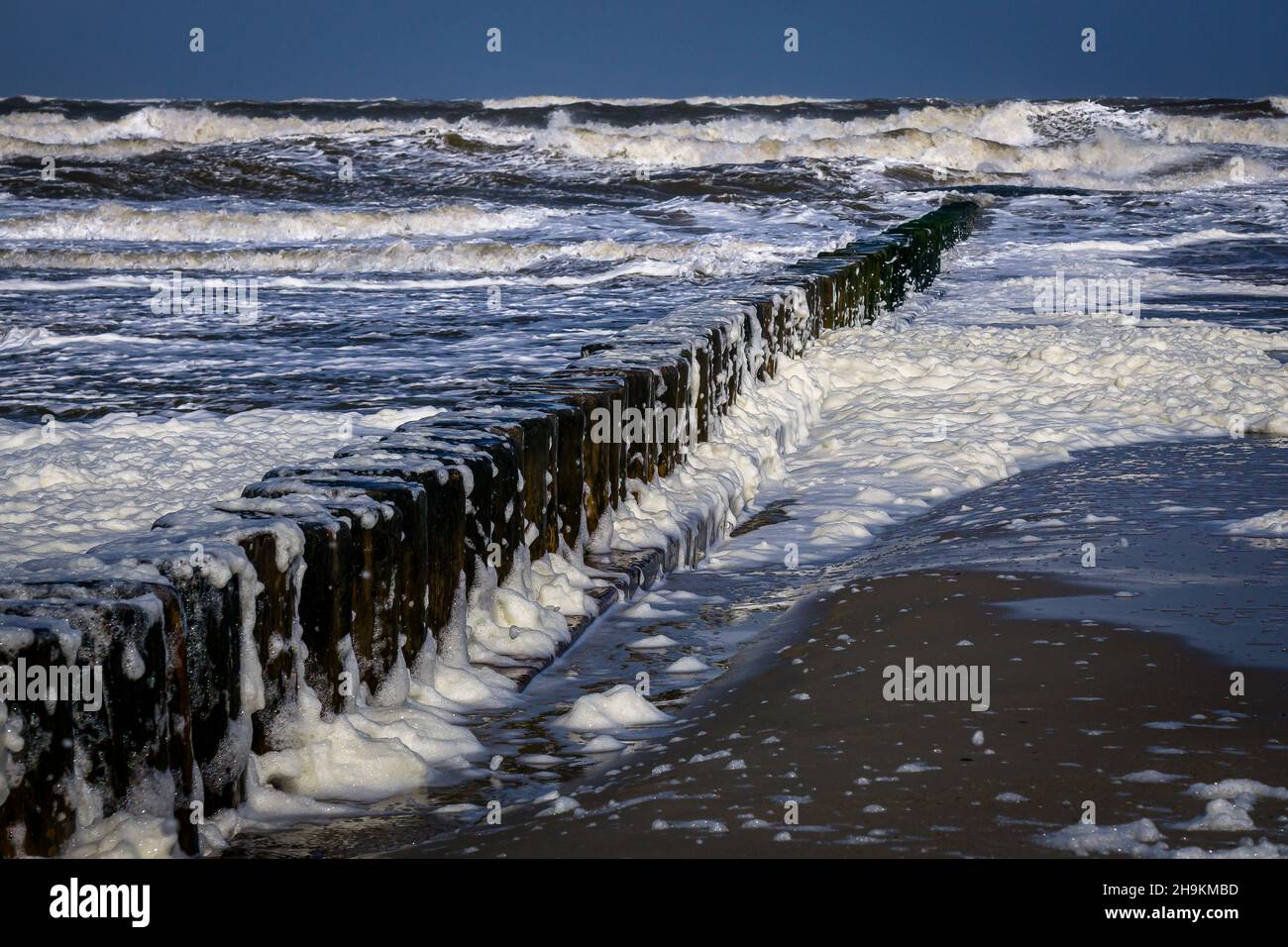 Beautiful view of the wavy sea hitting the stone wave breaker wall ...