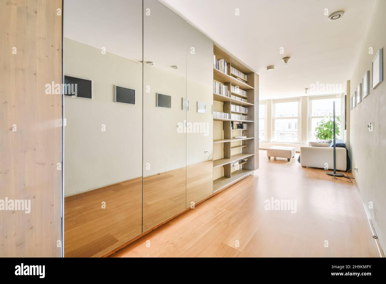 Long cozy corridor with full-wall glass cabinet Stock Photo - Alamy