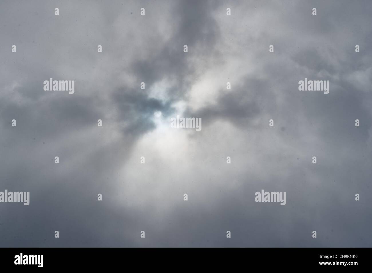 Cloudy sky snow falling from above Stock Photo - Alamy