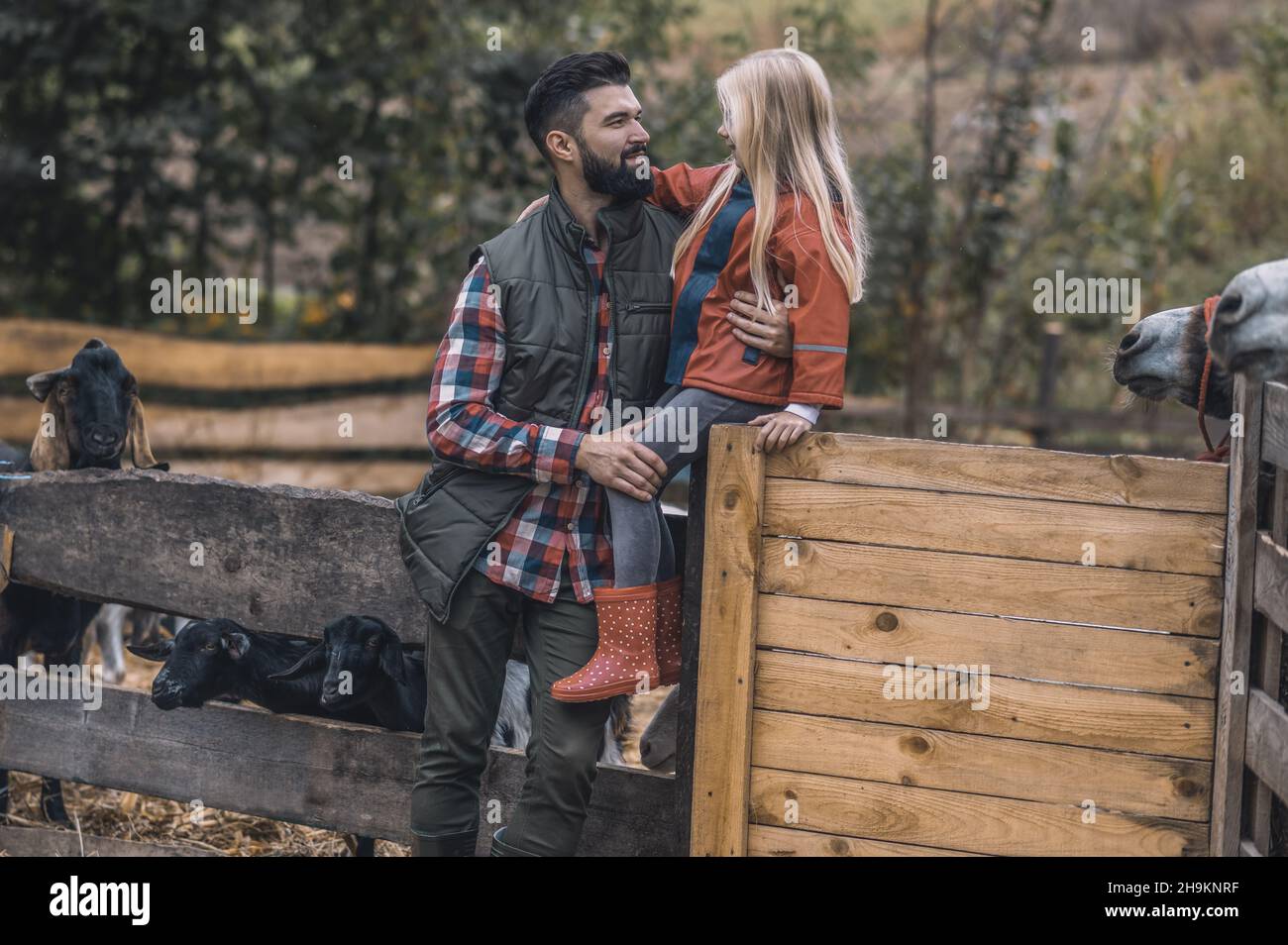 Farmer and his daughter spending time on a farm Stock Photo - Alamy