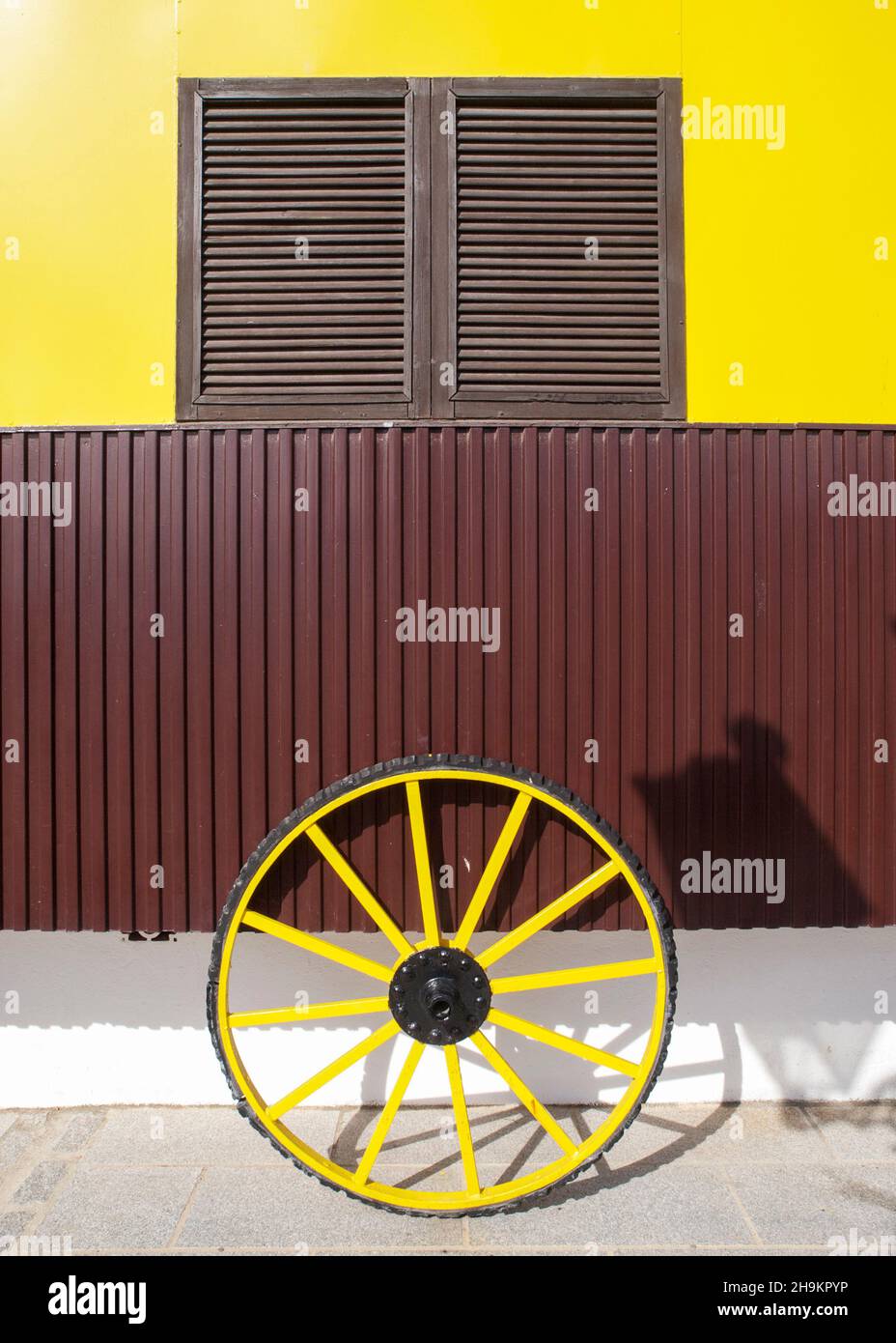 Wooden trolley with yellow wheel Stock Photo - Alamy