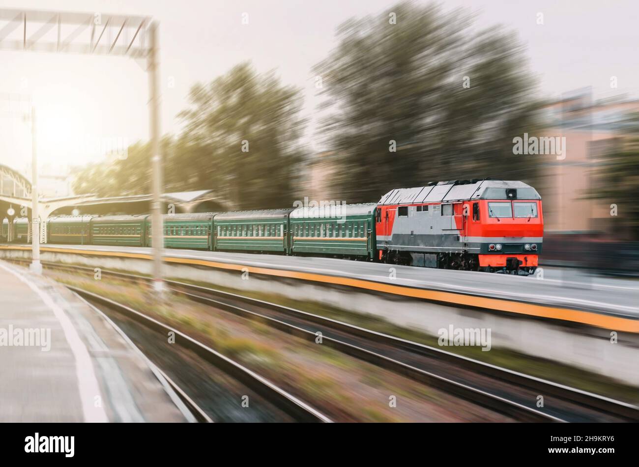 Modern diesel train with a passenger train departs from the station ...