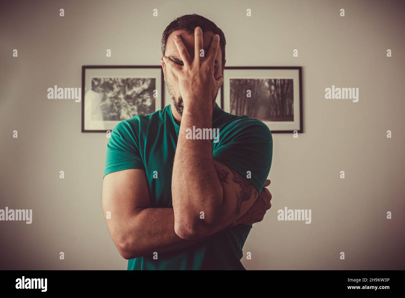Photograph of a man with his hand in front of his face Stock Photo - Alamy