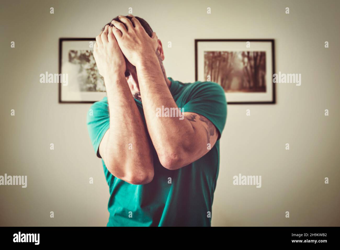 Photograph of a man with his hand in front of his face Stock Photo - Alamy