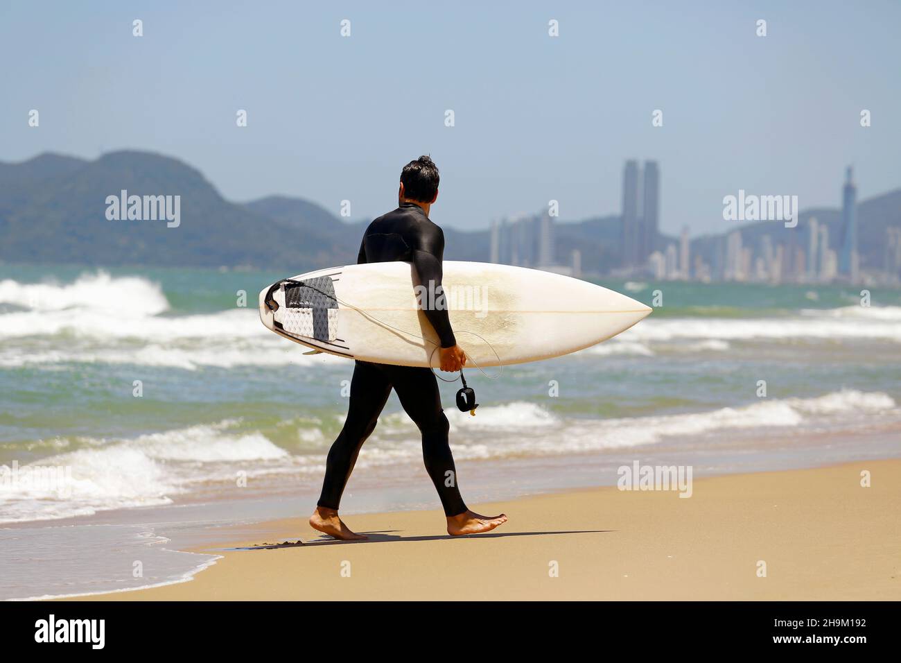 Surfer at beach. Surfing action water board sport. Men catching waves in ocean, isolated walking ...