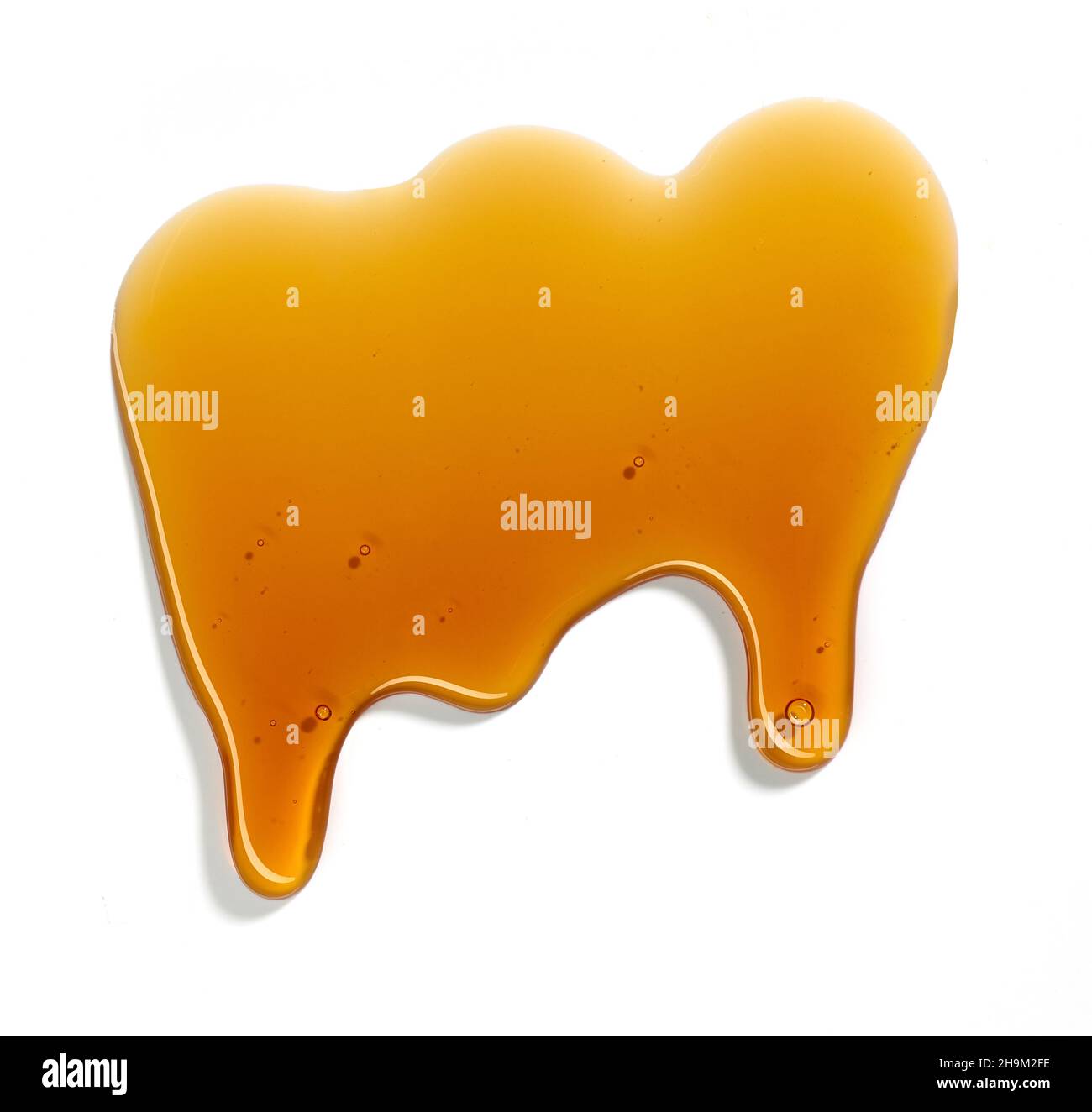 flowing brown sugar syrup isolated on white background Stock Photo - Alamy