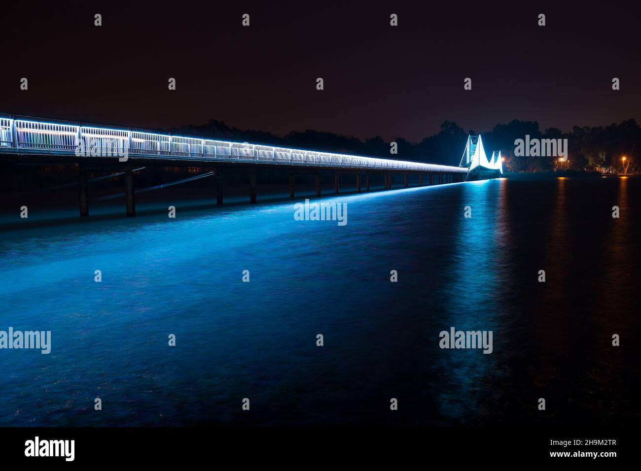 A blue lighted bridge at night Stock Photo - Alamy